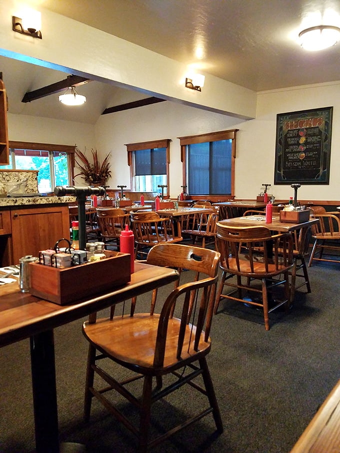 Evening light bathes the dining room in golden warmth. Those wooden chairs have supported countless happy diners through years of memorable meals.