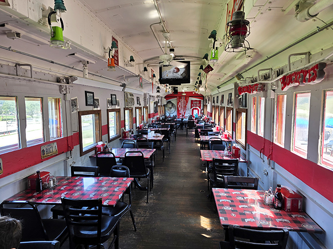 The narrow dining car creates an intimate atmosphere where every table feels like the best seat in the house.