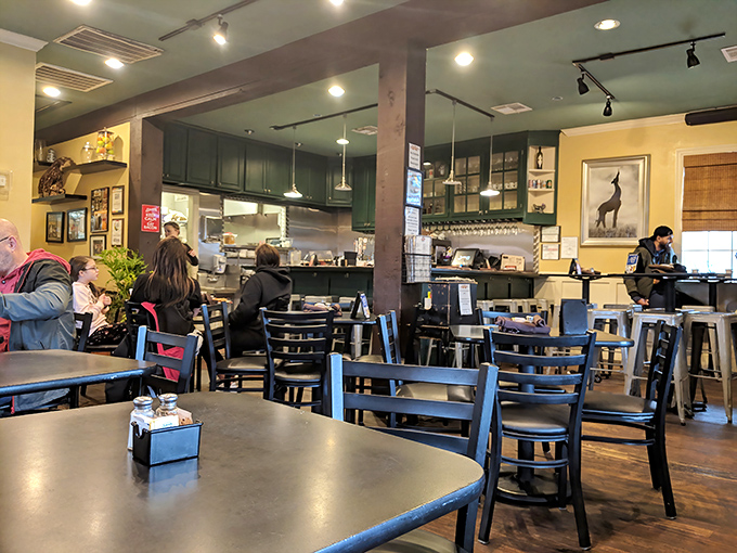 The dining area balances diner practicality with neighborhood charm &ndash; those blue chairs have heard thousands of "pass the syrup" requests.
