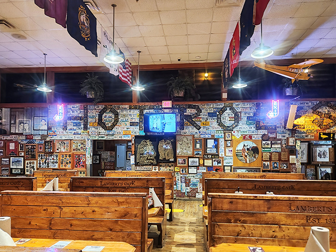 The dining room at Lambert's isn't just decorated&mdash;it's curated chaos, where every inch tells a story and every flag represents a visitor's home state.