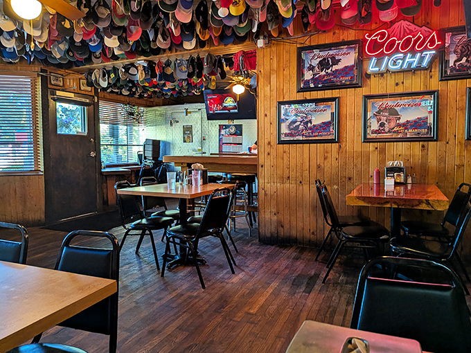 Wood-paneled walls, simple tables, and that magnificent hat collection. Dining rooms with Michelin stars have nothing on this authentic charm.
