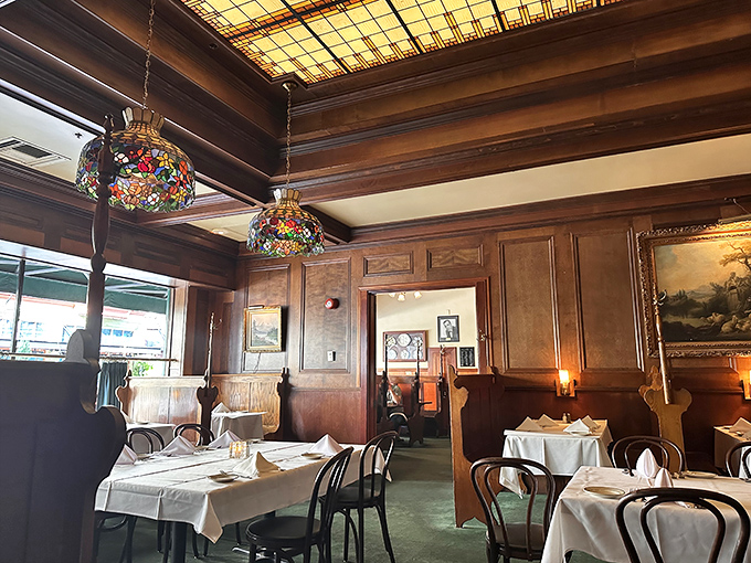 The dining room whispers of deals made, proposals accepted, and celebrations shared under those Tiffany-style lamps and wood-paneled walls.
