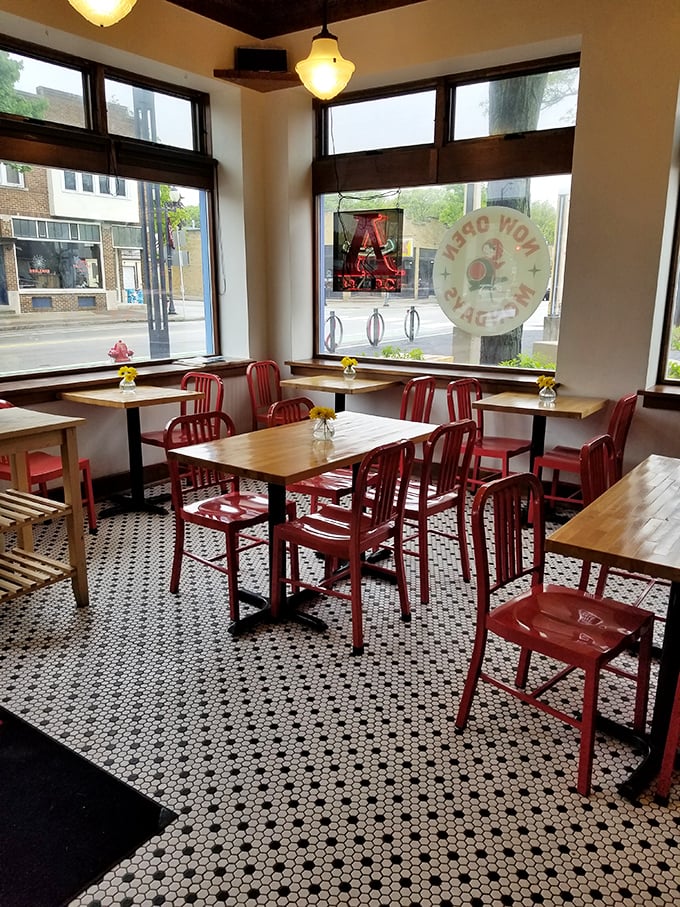 The dining area's red chairs aren't just seating&mdash;they're front-row tickets to the theater of Wauwatosa life unfolding outside those big windows.