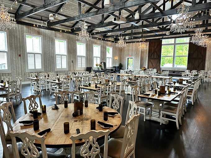 Dining room or Hollywood set? The soaring ceilings, weathered wood, and elegant white chairs create a space where memories are made before the first bite. 