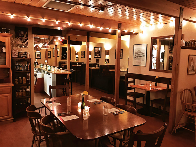 Evening at Storm Castle transforms the space into a warm, amber-lit haven where wooden beams and string lights create dinner magic.