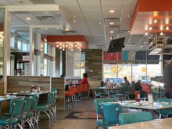 Retro-chic turquoise chairs pop against warm wood tones. The dining area balances nostalgia with modern comfort, like your favorite old song remixed just right.