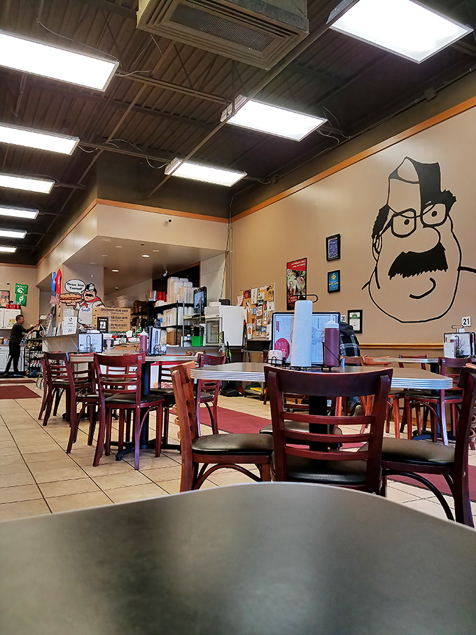 Simple tables, tiled floors, and that cartoon mascot watching over it all—sandwich church is now in session.