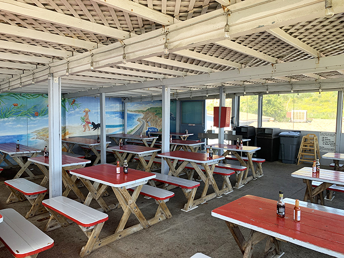Red-topped picnic tables under a latticed roof create the perfect casual dining atmosphere. Ocean views included at no extra charge.