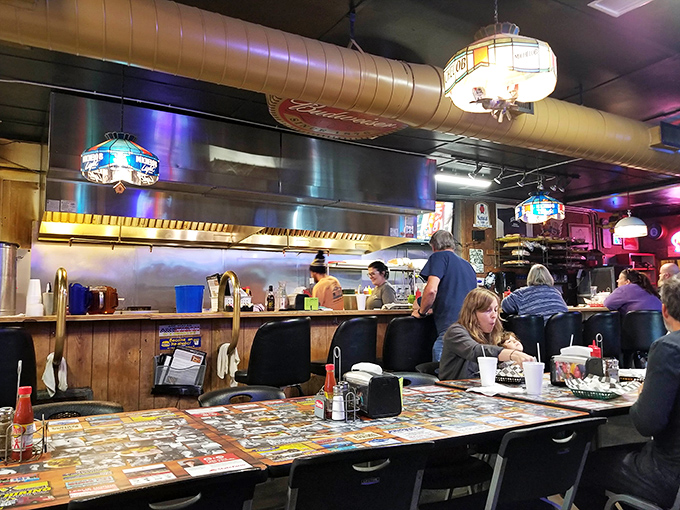 The open kitchen layout means you can watch your burger journey from raw potential to grilled masterpiece in real time glory.