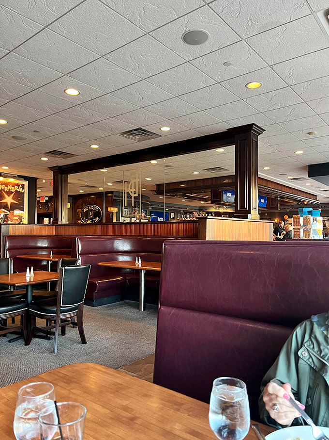 Burgundy booths and wood paneling create that classic supper club vibe where comfort meets class without either trying too hard.