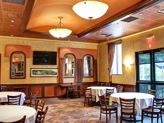 Another dining area showcases the restaurant's attention to architectural details with soft lighting from bowl fixtures creating an atmosphere where memories are made between bites.