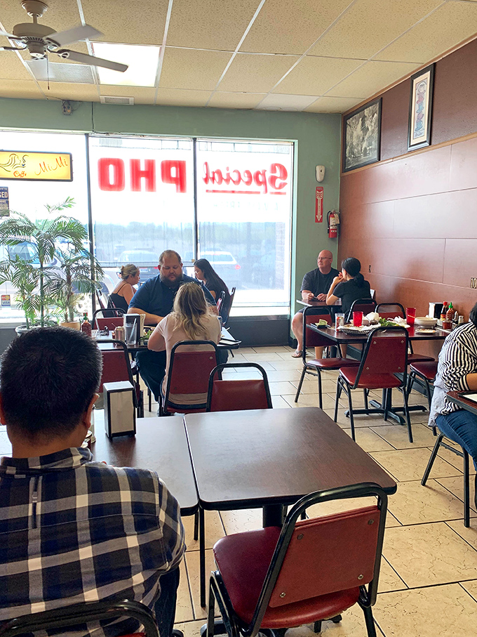 The dining area buzzes with the energy of people who've discovered something special. Red chairs and simple tables say "focus on the food, folks."