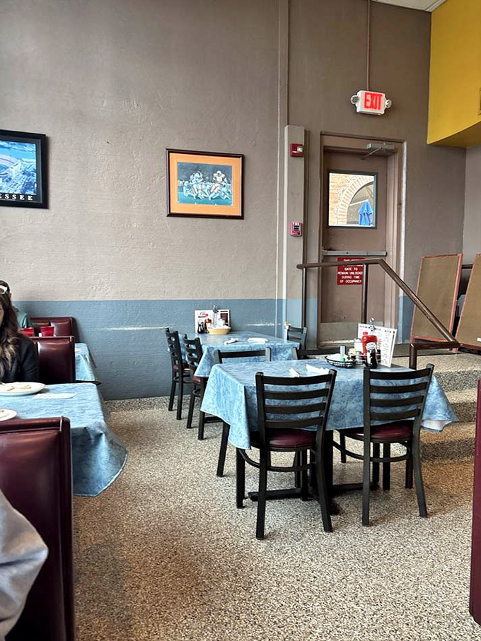 The dining area's unpretentious charm creates the perfect backdrop for making memories over meals. Those blue tablecloths have heard countless stories.