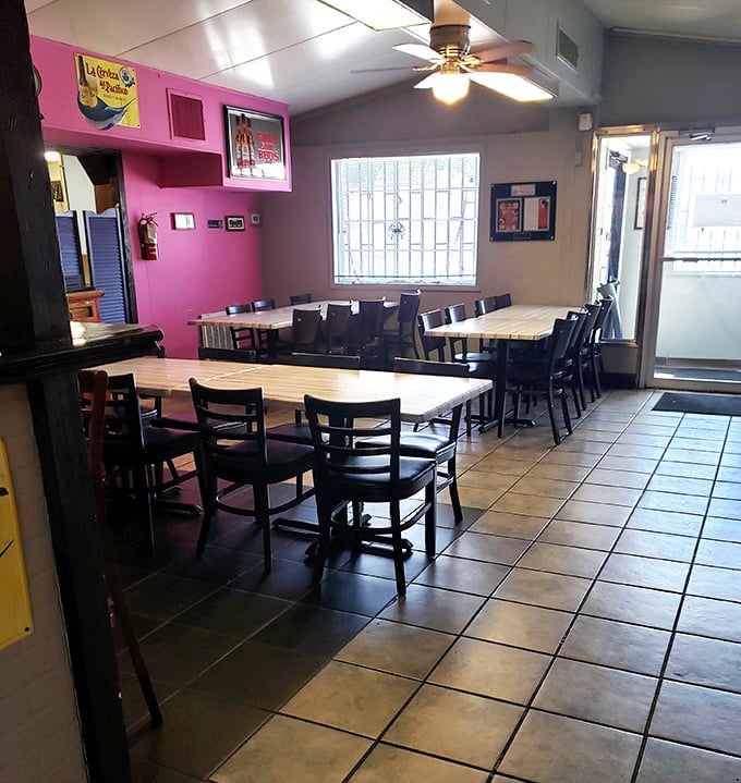 Long communal tables and bright pink walls create the kind of cheerful atmosphere where good meals become great memories.