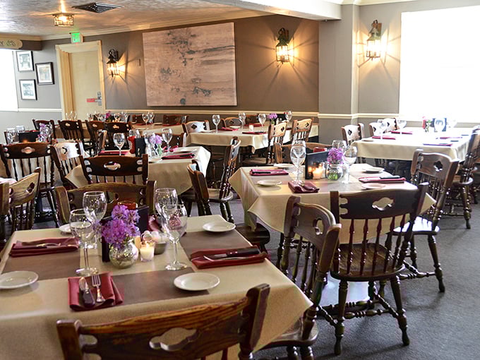 The dining room balances elegance with comfort&mdash;white tablecloths say "special occasion" while wooden chairs whisper "stay awhile."