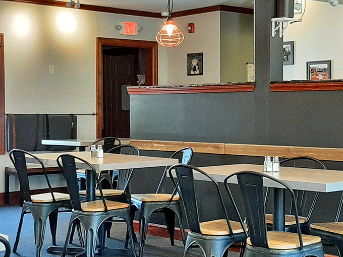 Metal chairs, wooden tables, and industrial lighting create a dining space that's both modern and timeless – like barbecue itself.