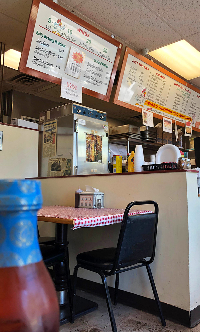 Classic red-and-white checkered tablecloths set the stage for BBQ authenticity. No pretension here, just the promise of good eating.