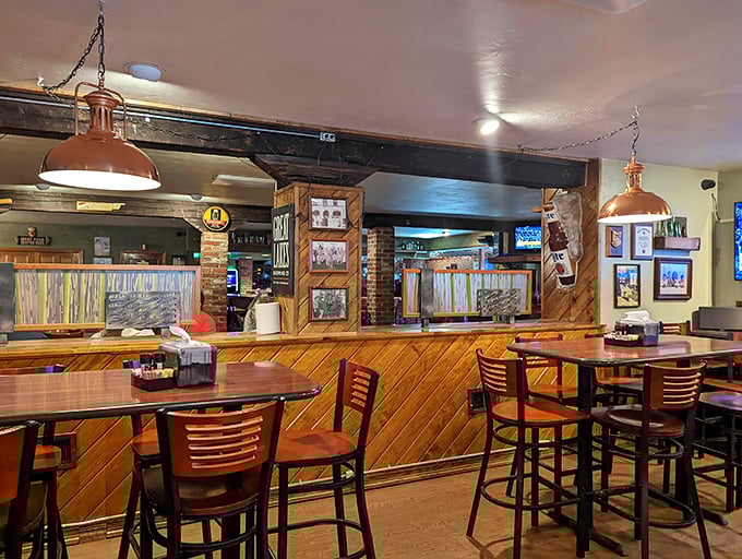 Warm wood paneling and copper pendant lights create the cozy atmosphere every neighborhood pub aspires to achieve.