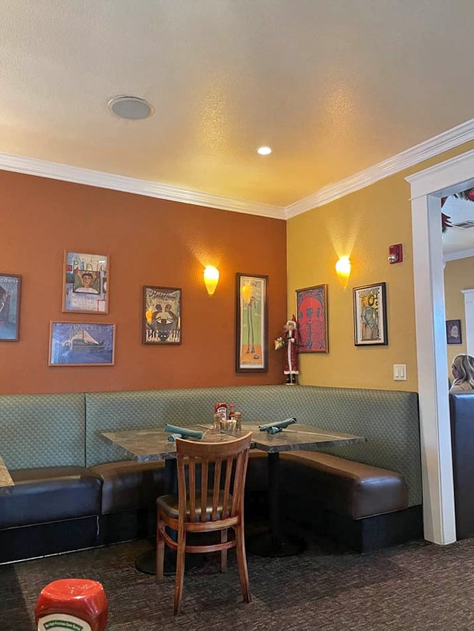 Cozy booth seating surrounded by warm terracotta walls and eclectic artwork creates the perfect nook for lingering over that second cup of coffee.