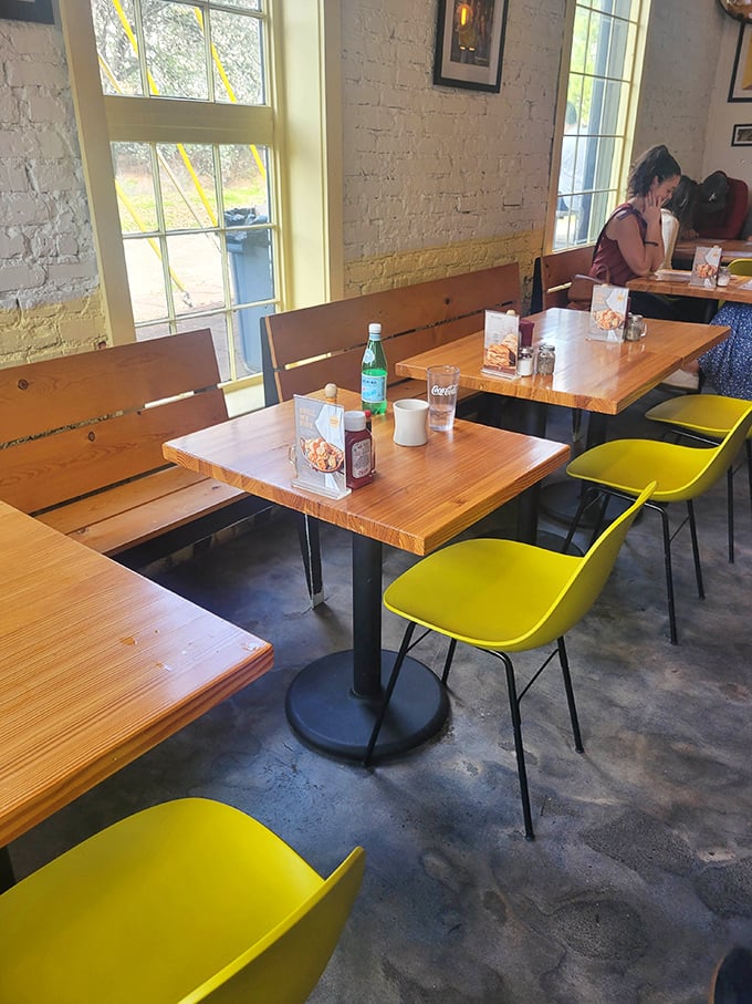 Wooden tables, yellow chairs, and exposed brick create the perfect backdrop for the serious business of biscuit appreciation. 
