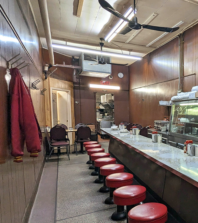 The narrow dining room feels like a portal to simpler times. Every seat has a story, and every meal creates a new memory.