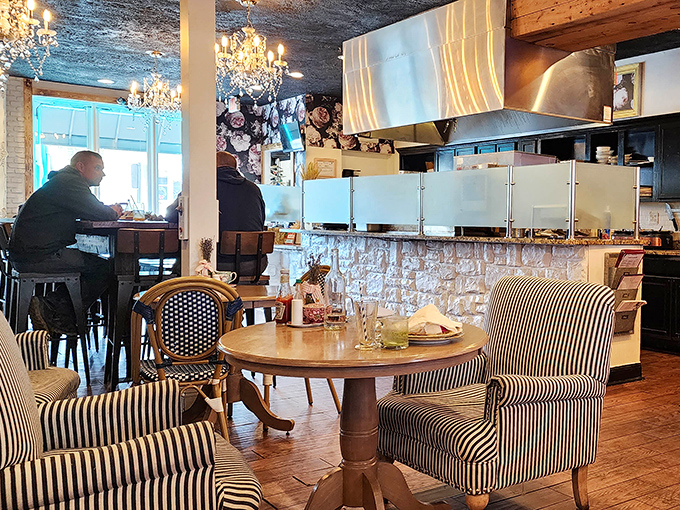 Striped chairs and crystal chandeliers create an atmosphere where comfort meets class. Like wearing your favorite jeans to the symphony.