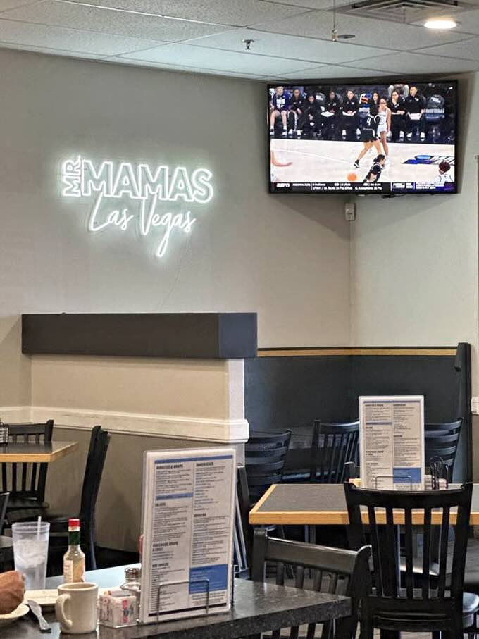 The neon "Mr. Mamas Las Vegas" sign glows like a beacon for hungry souls. Even the TV seems to be watching the diners eat.