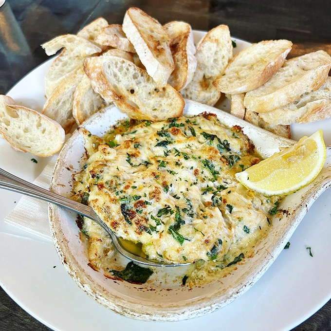 Bubbling hot dip that's worth the wait for it to cool down. Those toasted baguette slices are merely vehicles for cheesy goodness.