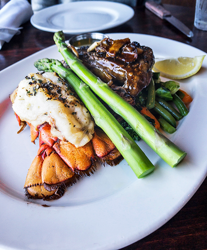 Ocean's finest trio: tender lobster tail, perfectly grilled salmon, and prawns that look like they jumped straight from sea to grill to your plate.