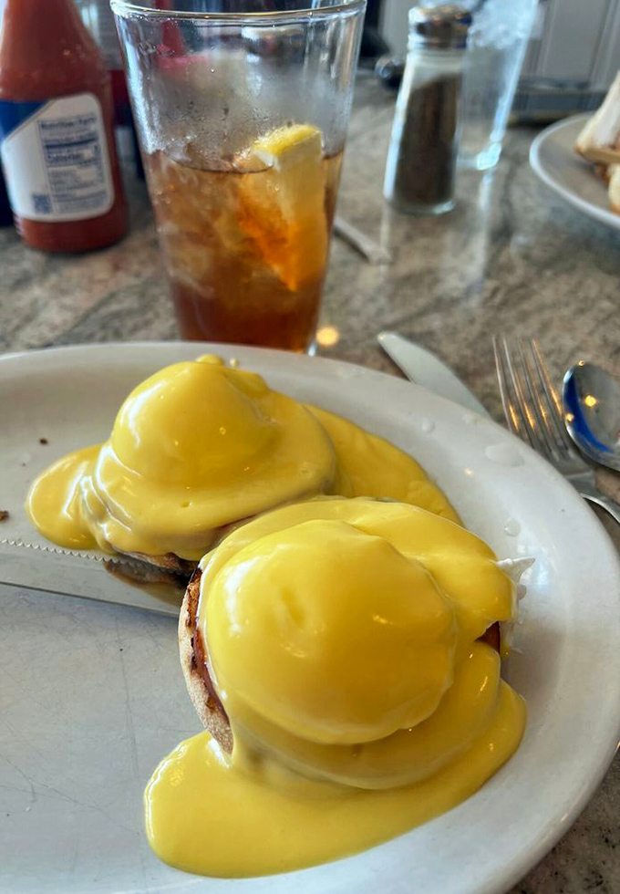 Eggs Benedict with hollandaise cascading like a yellow waterfall of buttery goodness. Breakfast's answer to formal wear&mdash;elegant but still comfortable.
