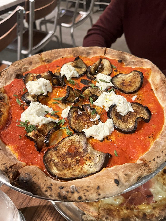Roasted eggplant and creamy cheese create a vegetarian masterpiece. Proof that meatless doesn't mean joyless in the pizza universe.