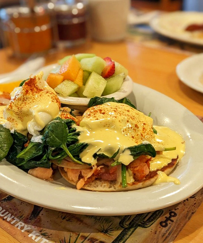 Eggs Benedict island-style: hollandaise cascading over perfectly poached eggs with a side of fresh fruit that makes you feel slightly virtuous.
