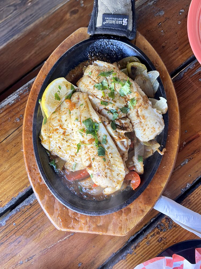 Fish so fresh it practically introduces itself. Served sizzling in its own skillet with vegetables that know their supporting role.