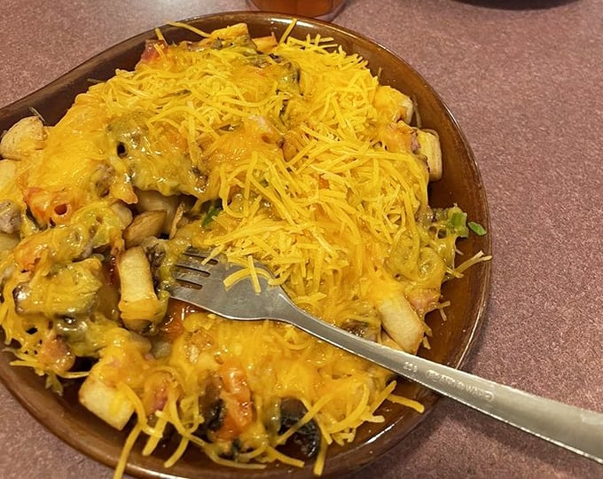 The farmer's skillet arrives like a golden treasure chest overflowing with cheesy breakfast perfection.