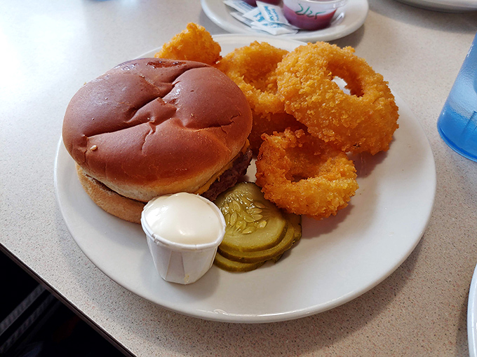 A perfectly fried sandwich with golden onion rings that crunch like autumn leaves. Fast food chains weep with envy.