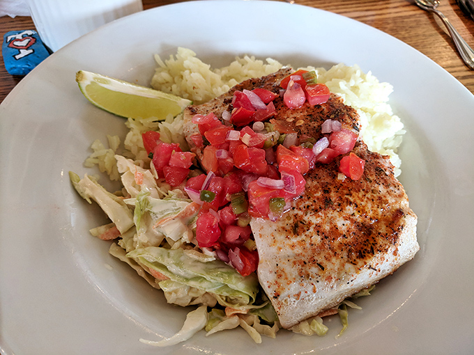 The Fish Taco Bowl transforms blackened mahi-mahi into a coastal celebration with jasmine rice, fresh pico, and a lime wedge for zesty punctuation.