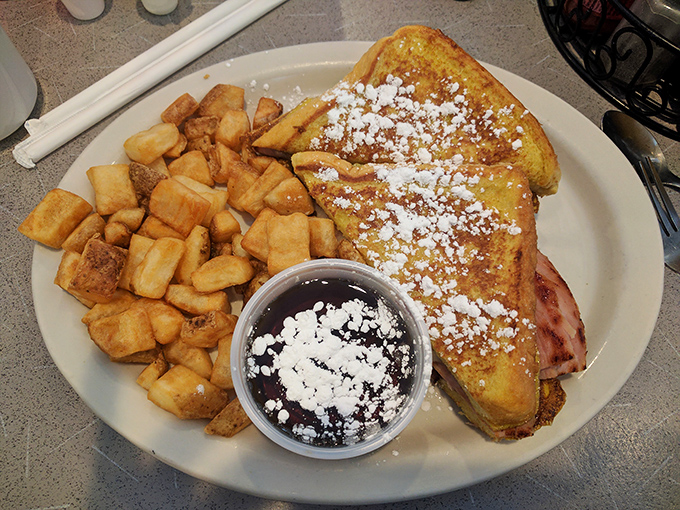 The Flying Pig Sandwich pays delicious homage to Cincinnati's winged mascots with a tower of ham, bacon, and egg on French toast.