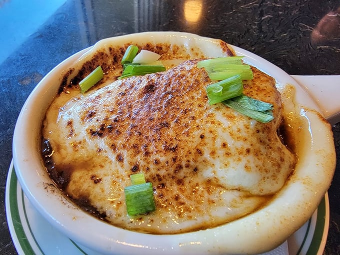 French onion soup with a cheese cap so perfect it deserves its own standing ovation. Spoon-breaking satisfaction guaranteed.
