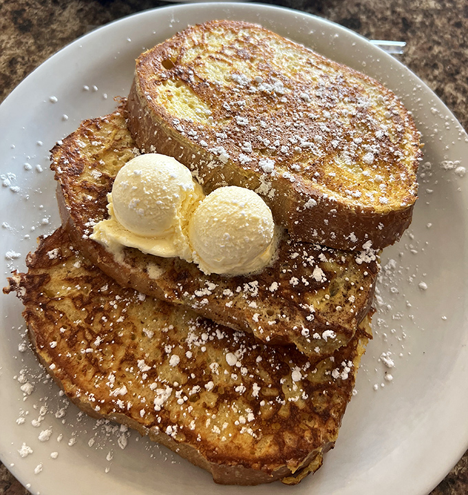 French toast that's been living its best life. Those two scoops of vanilla ice cream aren't just garnish&mdash;they're essential companions.