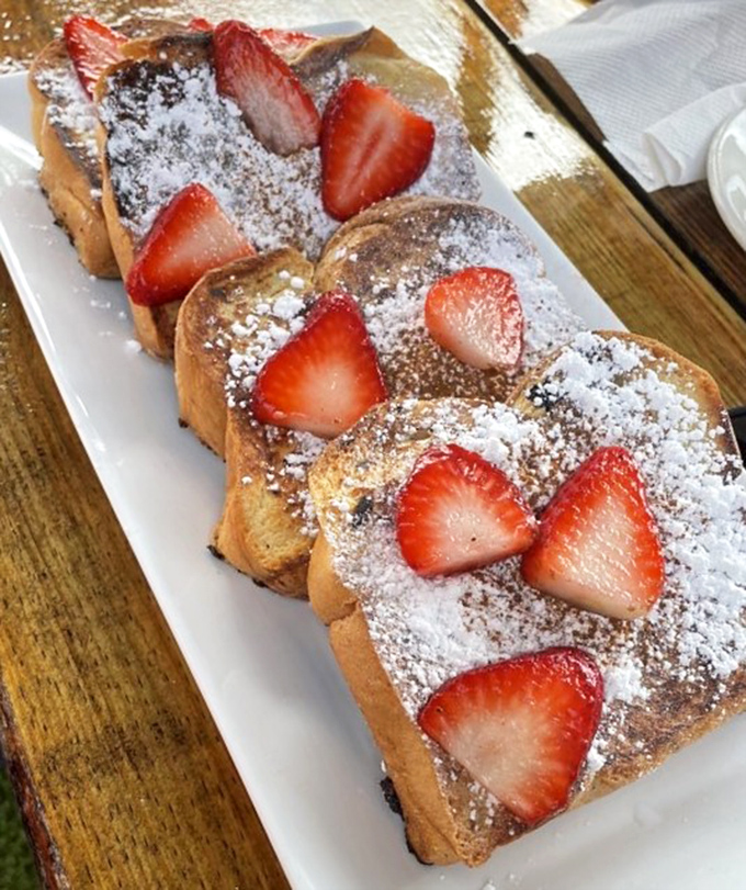 French toast adorned with strawberries and powdered sugar&mdash;breakfast masquerading as dessert, and nobody's complaining about the deception.