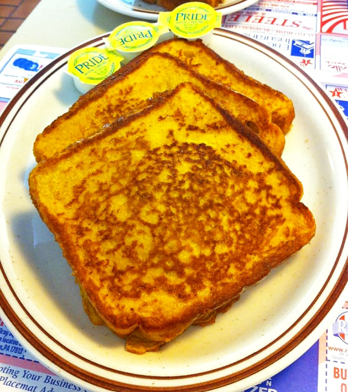 French toast that would make France jealous. Golden-brown perfection with those little butter packets standing by like loyal soldiers.