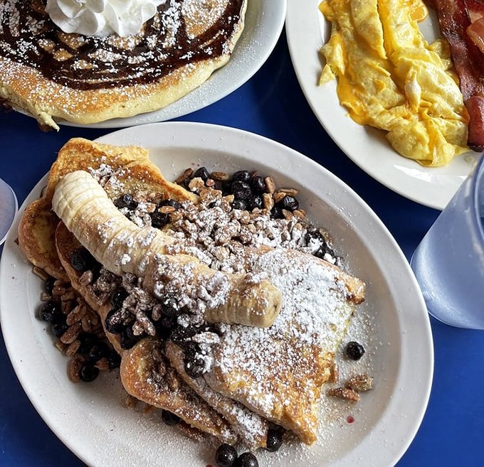 French toast that's dressed for success with powdered sugar, fresh fruit, and enough decadence to make Monday morning feel like Saturday.