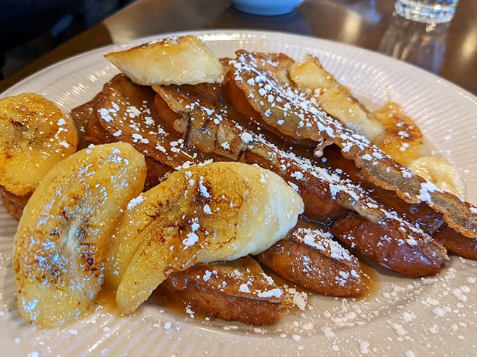 French toast that's been dipped, griddled, and powdered to perfection. Those caramelized bananas aren't just toppings &ndash; they're breakfast jewelry.