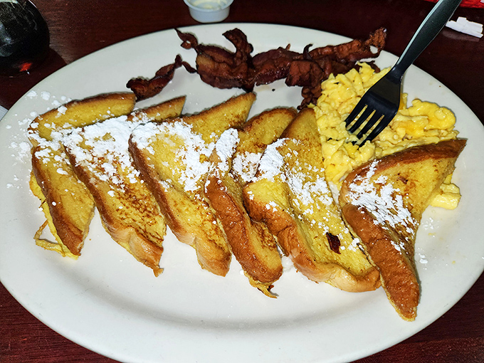 French toast that puts France on notice. Dusted with powdered sugar and served with crispy bacon&mdash;breakfast harmony achieved.