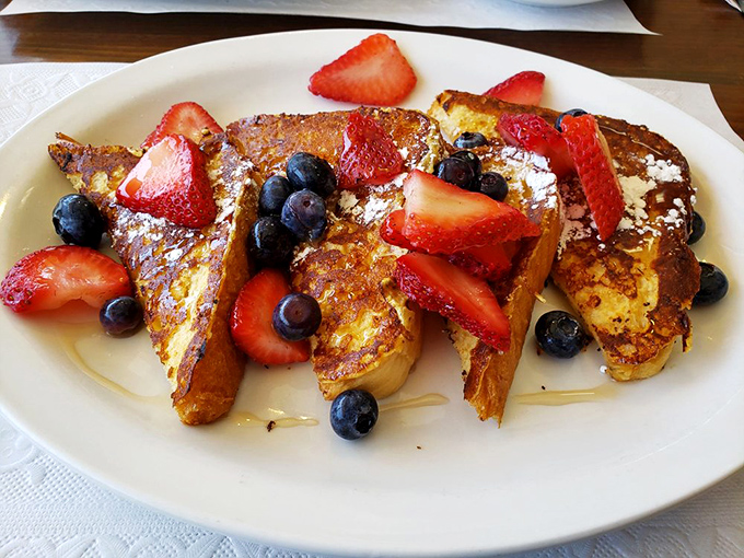 French toast wearing fresh berries like jewelry&mdash;a breakfast that's dressed better than most people on vacation.