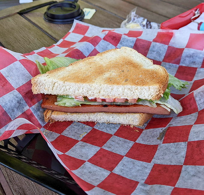 The humble fried bologna sandwich gets the respect it deserves here, transformed from lunchbox staple to legitimate culinary contender.