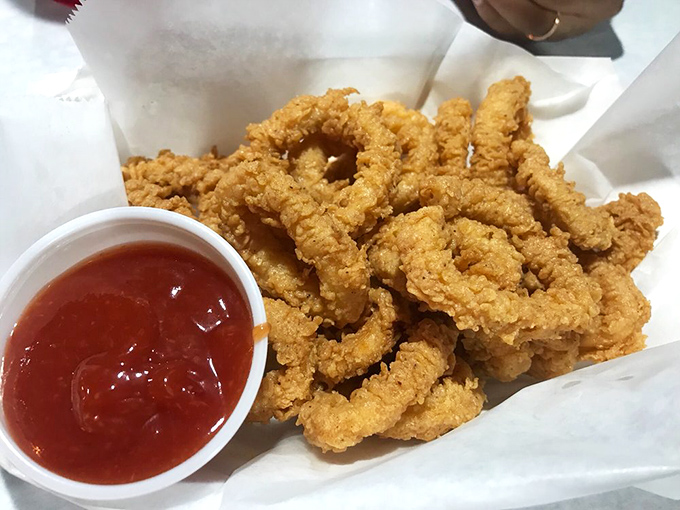Crispy calamari that avoids the rubber-band texture trap, served with a side of marinara for essential dipping.