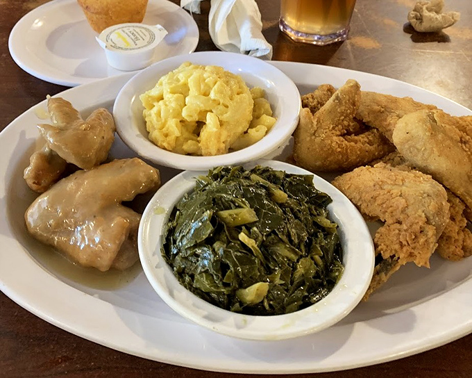 The holy trinity of Southern cooking: perfectly fried chicken, collard greens cooked with love, and mac and cheese that could make a grown person weep with joy.