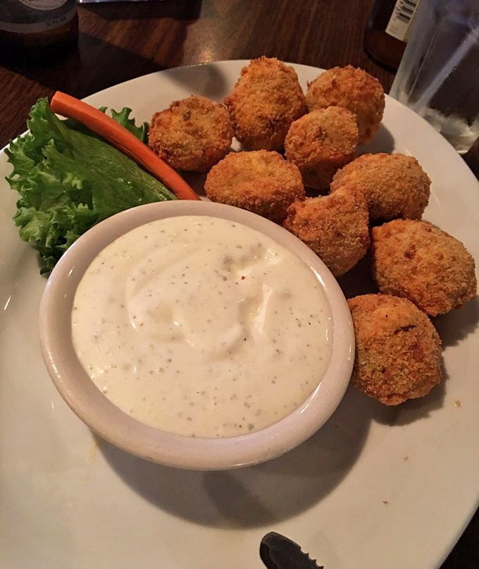 Golden-fried mushrooms with creamy dipping sauce: the kind of appetizer that makes you order a second round immediately.