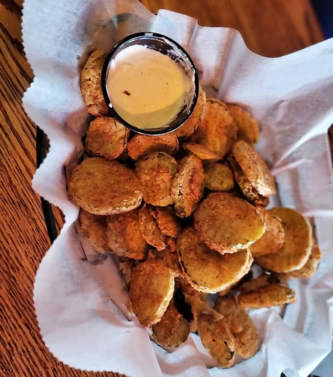 Fried pickles that achieve the impossible: maintaining their crunch while delivering that perfect vinegary tang, with a dipping sauce that complements rather than overwhelms.